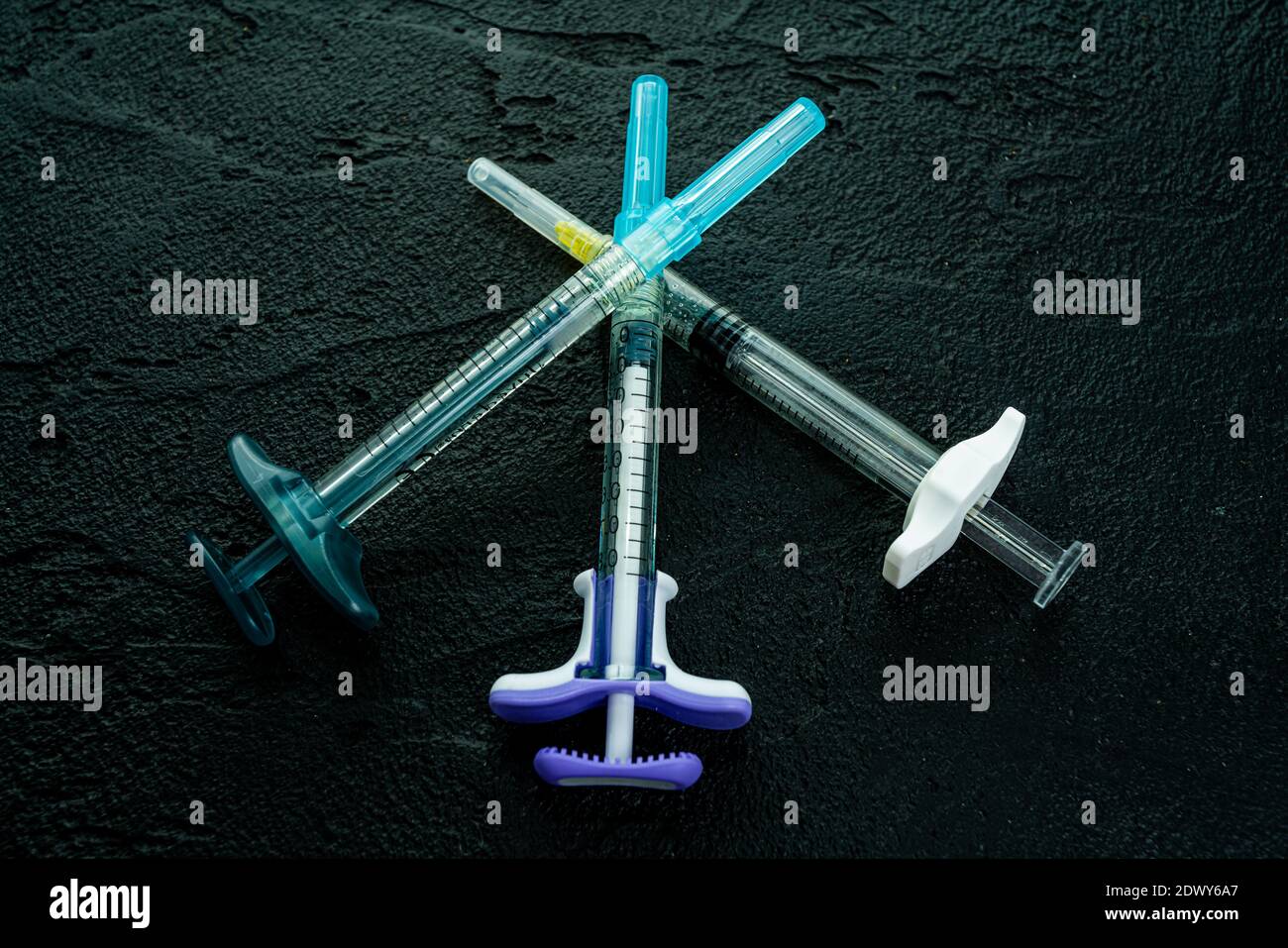 cosmetology injections. Plastic syringe on black background. Medical ...