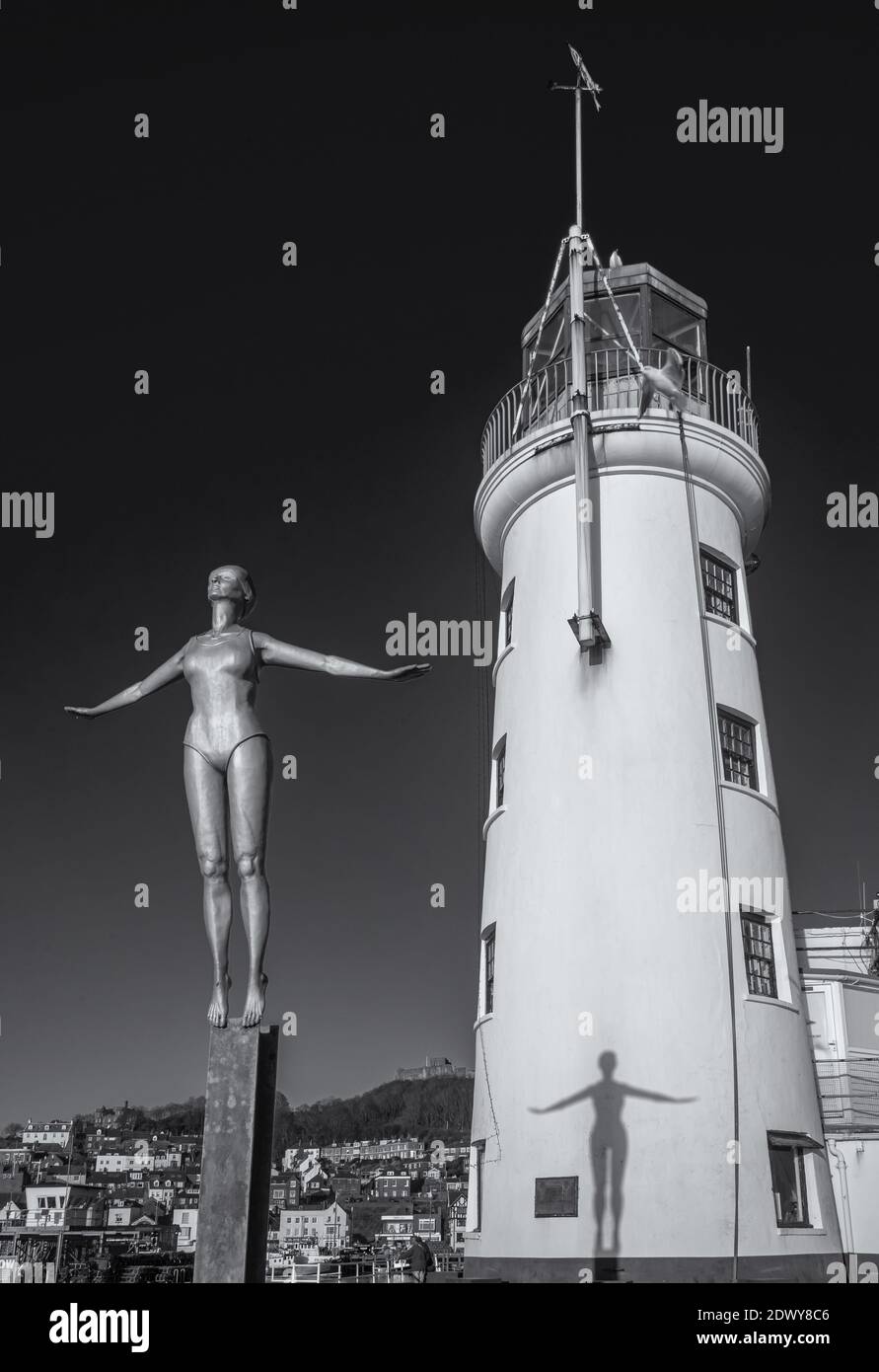 The lighthouse at Scarborough with a memorial figure with outstretched ...