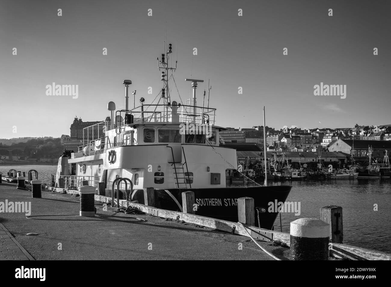 The Southern Star boat moored in a harbour with a the light from a low ...