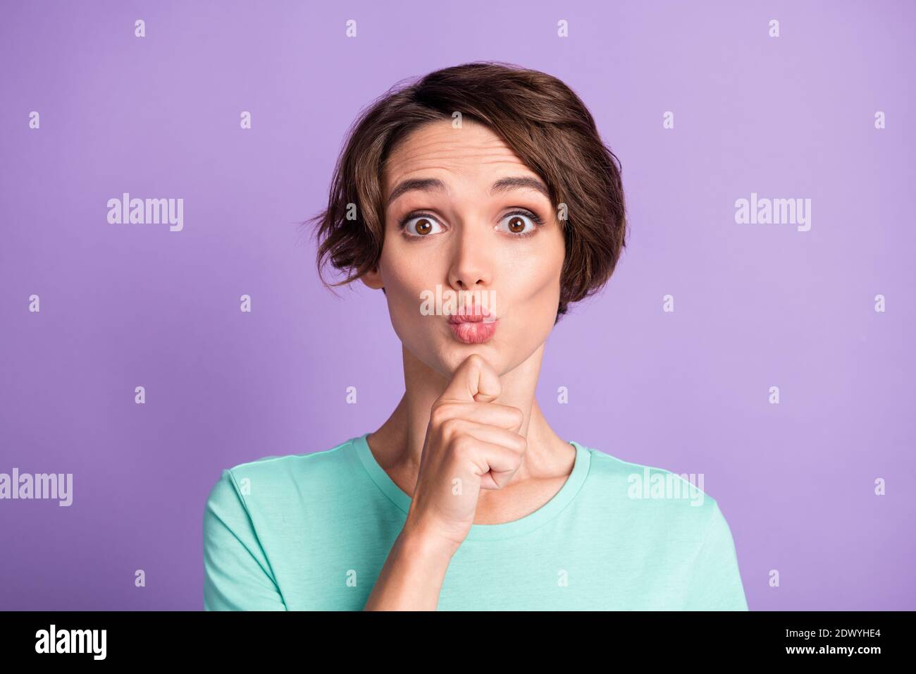 Close up portrait of lovely young person arm on chin kiss lips teal ...