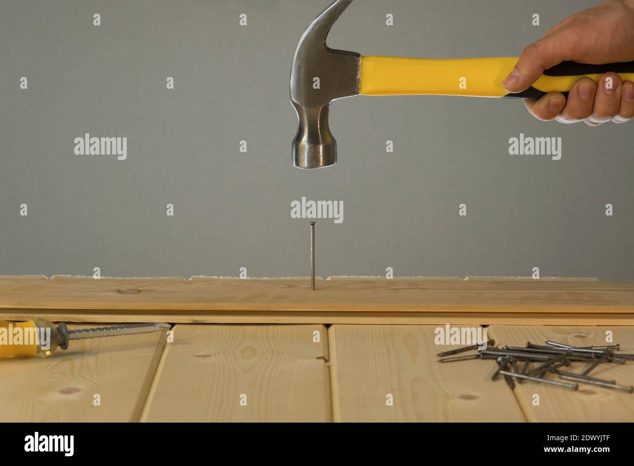 Hammer Hitting Nail On The Head. DIY. Carpenter hands with hammer wood ...