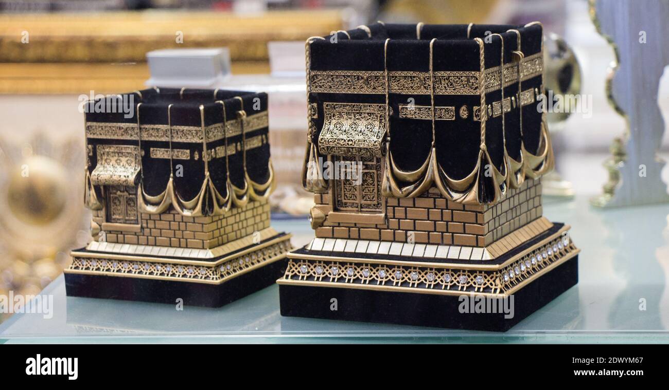A low angle view of tiny statues representation Kaaba, on the table ...