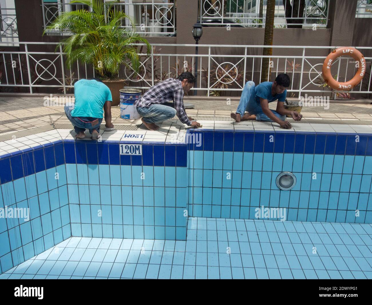 Bangladeshi migrant workers at working at a swimming pool in a luxury ...
