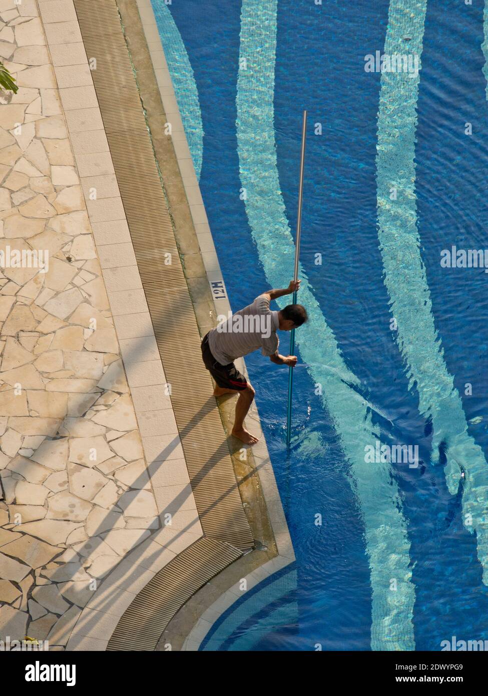 Bangladeshi migrant workers at working at a swimming pool in a luxury ...