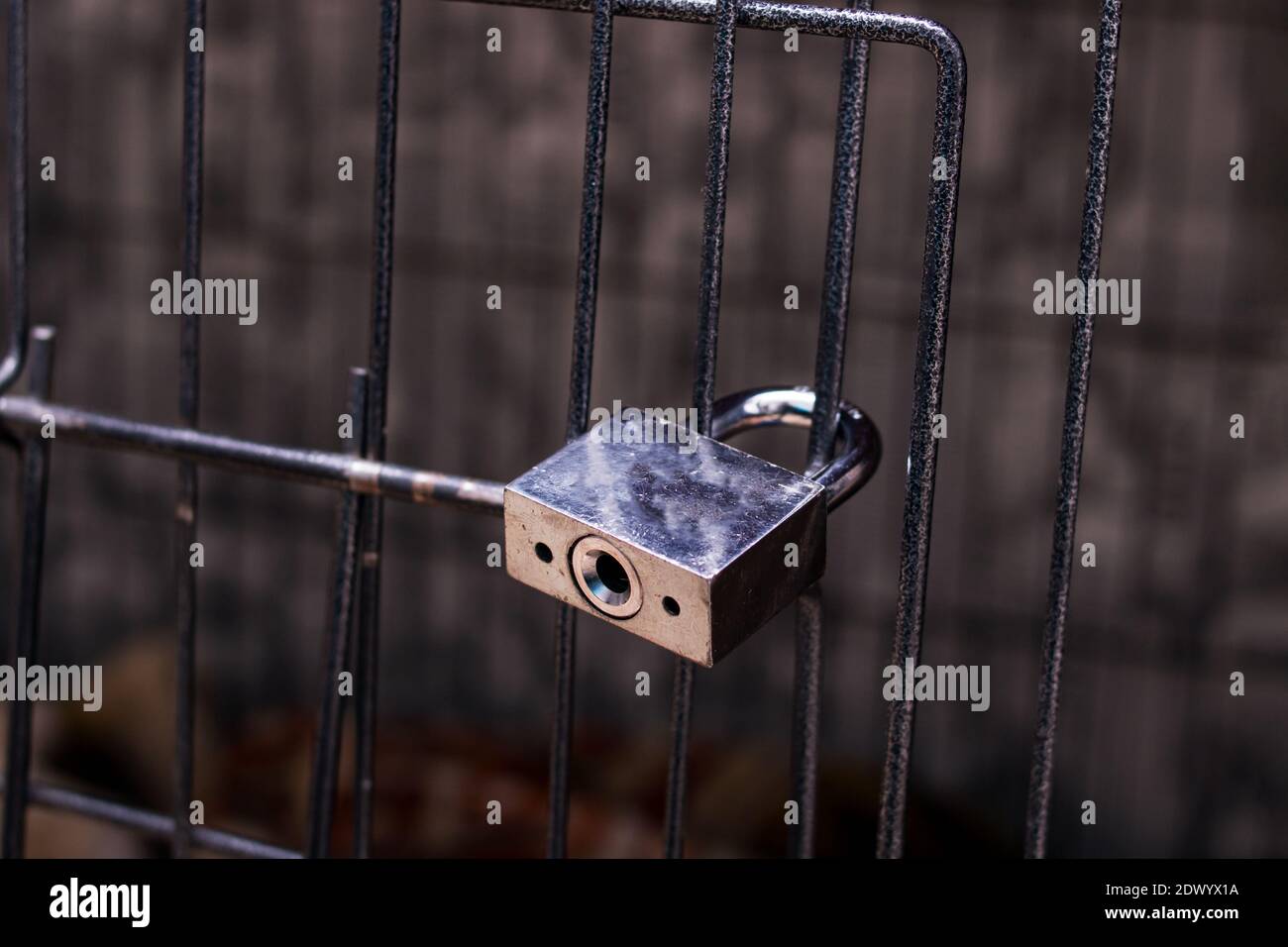 Hanging closed lock on the gate closeup Stock Photo - Alamy
