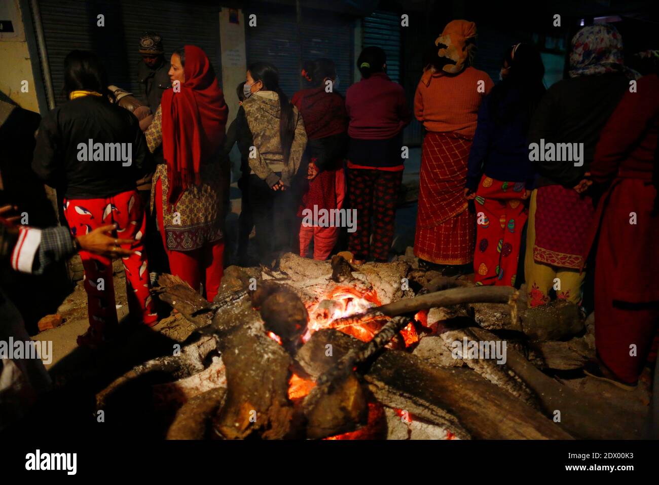 Kathmandu, Nepal. 23rd Dec, 2020. Nepalese people warm themselves ...