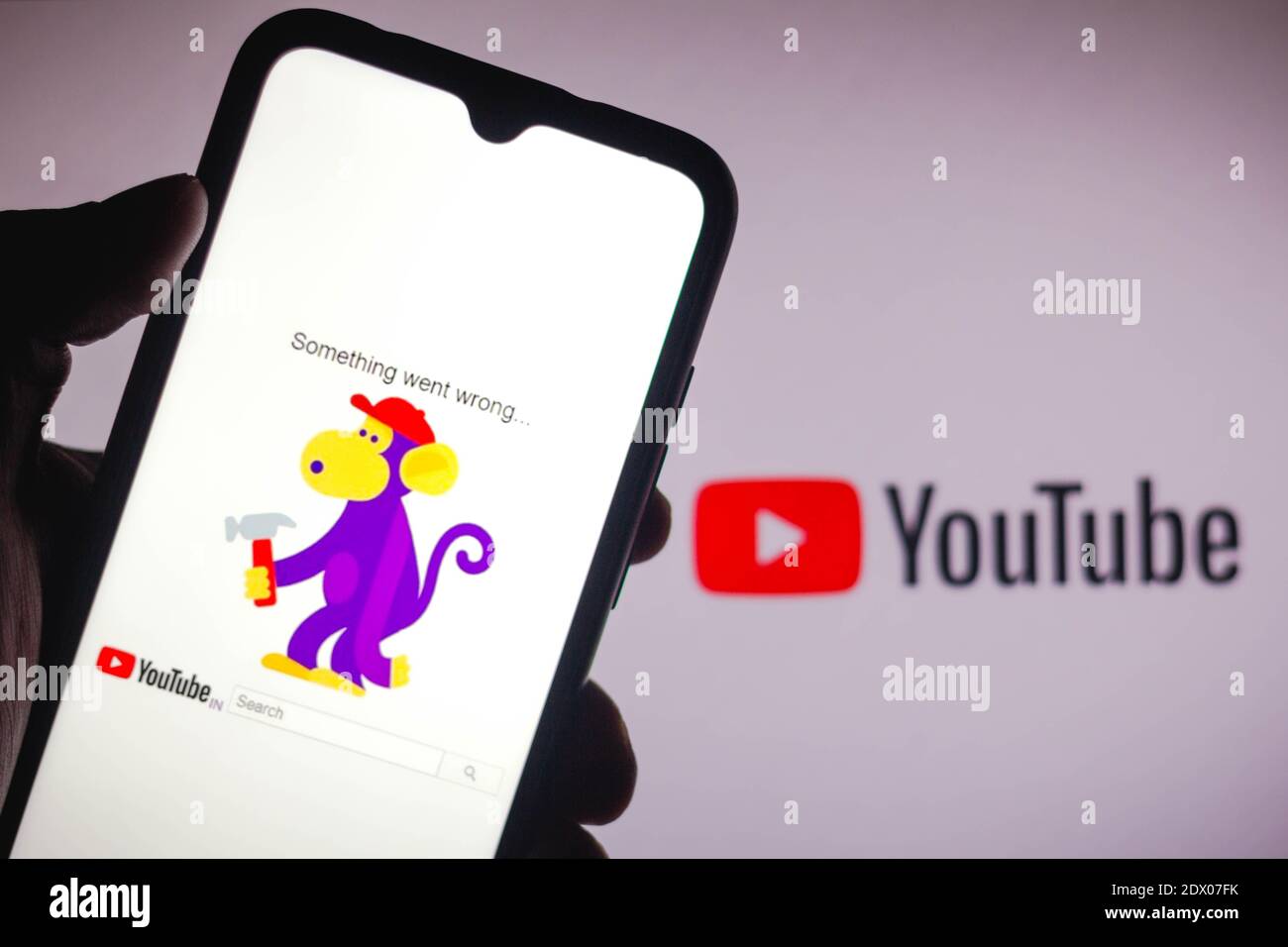 In this photo illustration a Youtube logo seen displayed on a smartphone. "Something went wrong ...