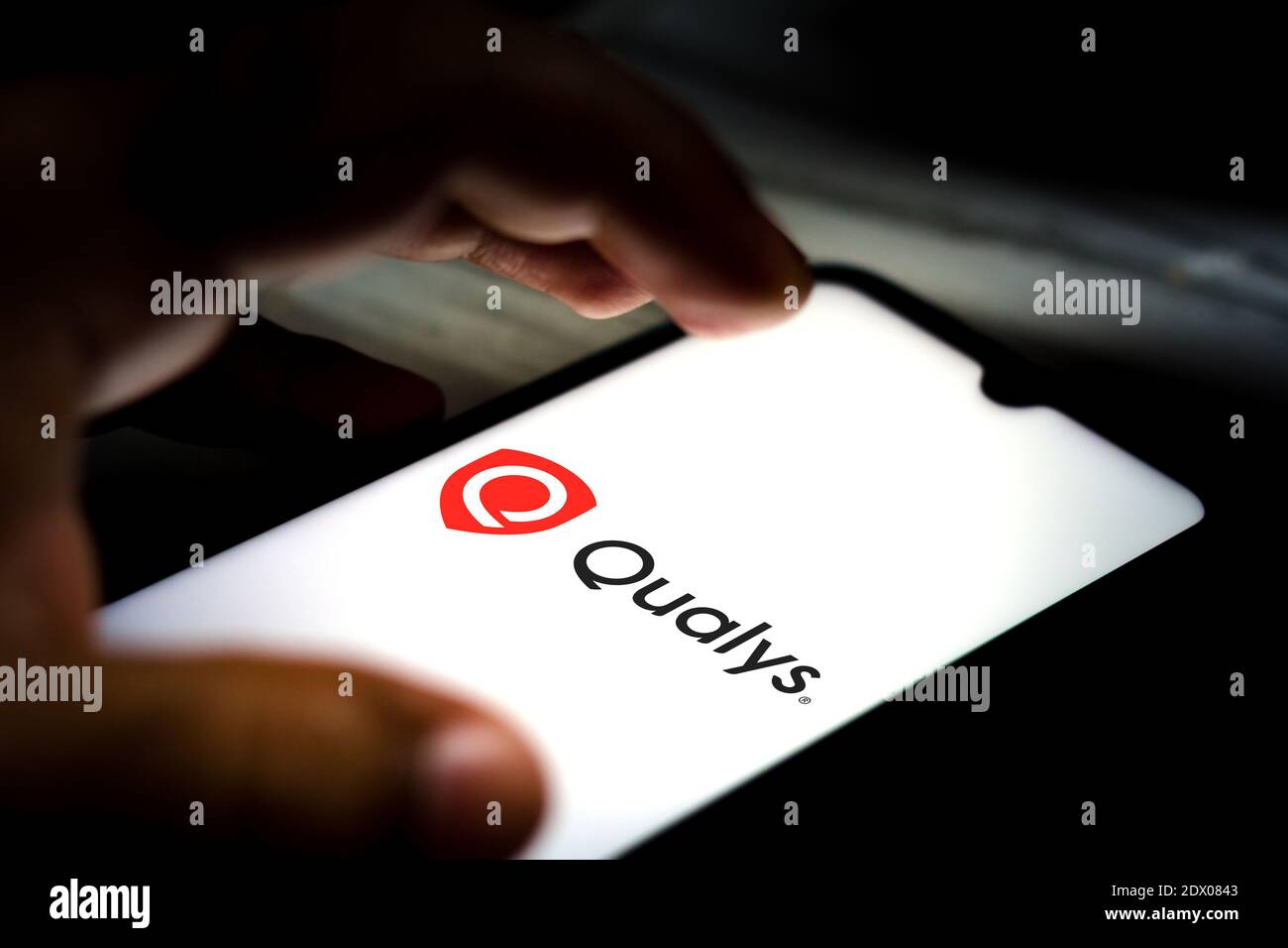 In this photo illustration the Qualys logo seen displayed on a ...