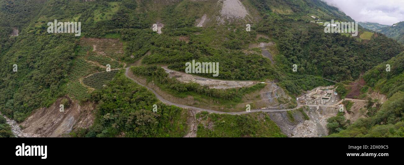 Roads and deforestation on the mountainside above an Andean river ...