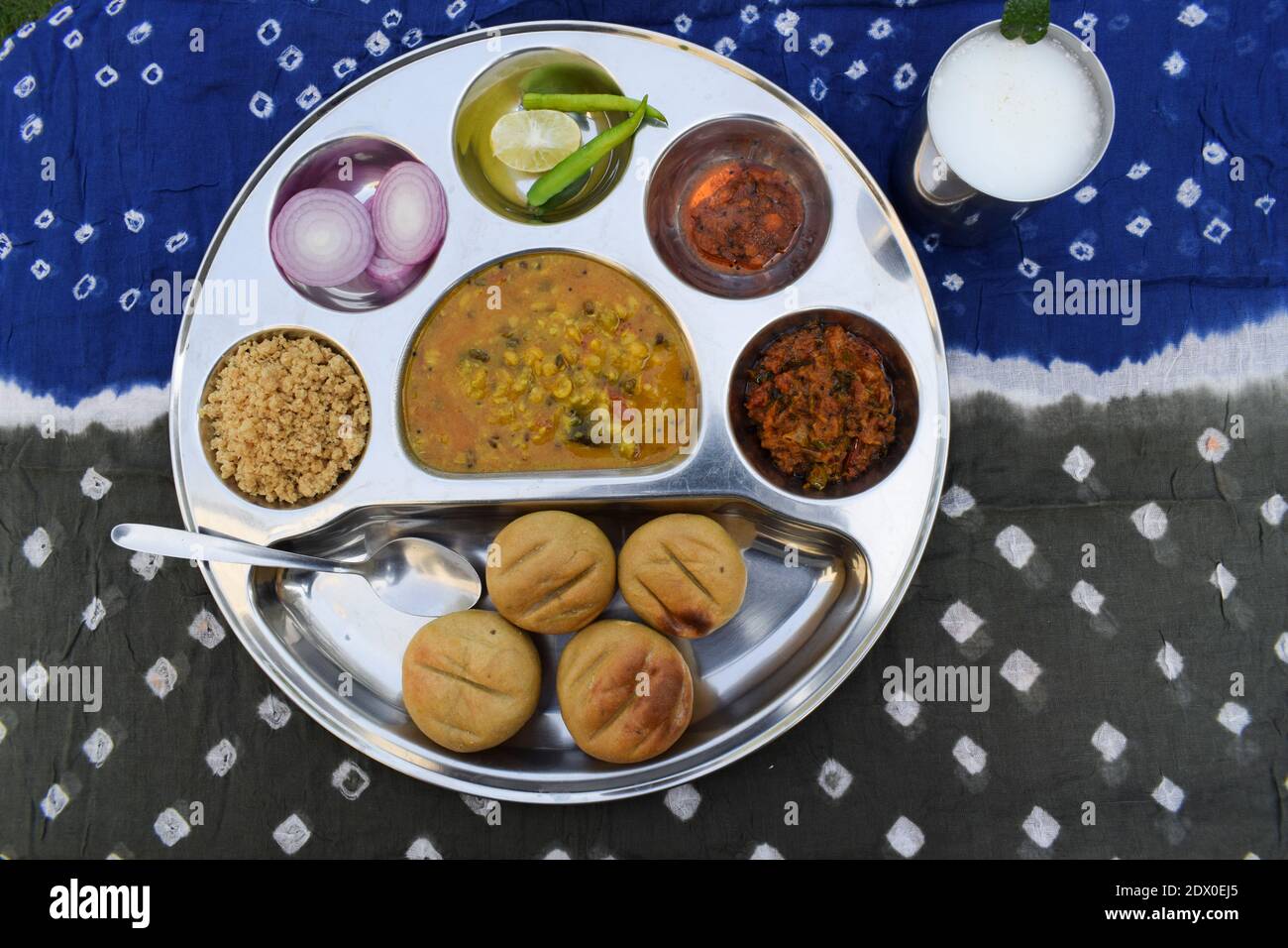 Popular Rajasthani food Dal bati served with salads, tomato chutney ...
