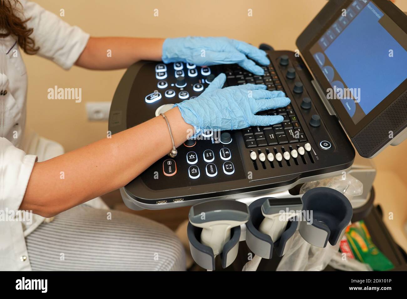 Ultrasound medical device for diagnostics, female doctor hands on the ...