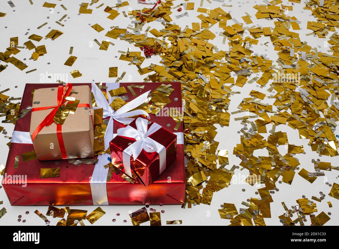 Three presents on the floor covered with golden confetti Stock Photo ...
