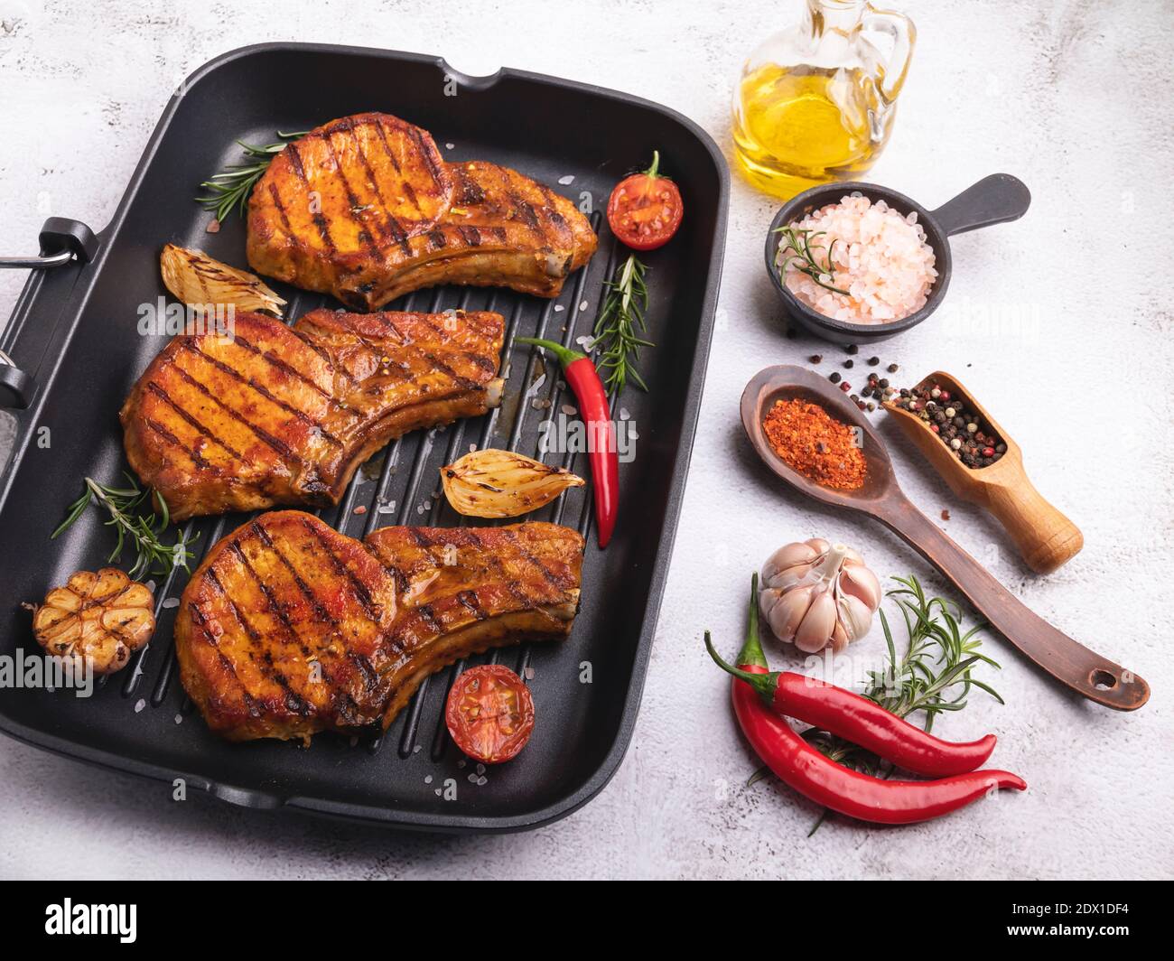 cooked grilled meat pork, beef, chop on bone, on grill pan, spices ...