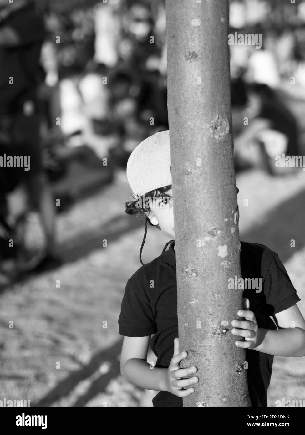 Boy behind tree Black and White Stock Photos & Images - Alamy