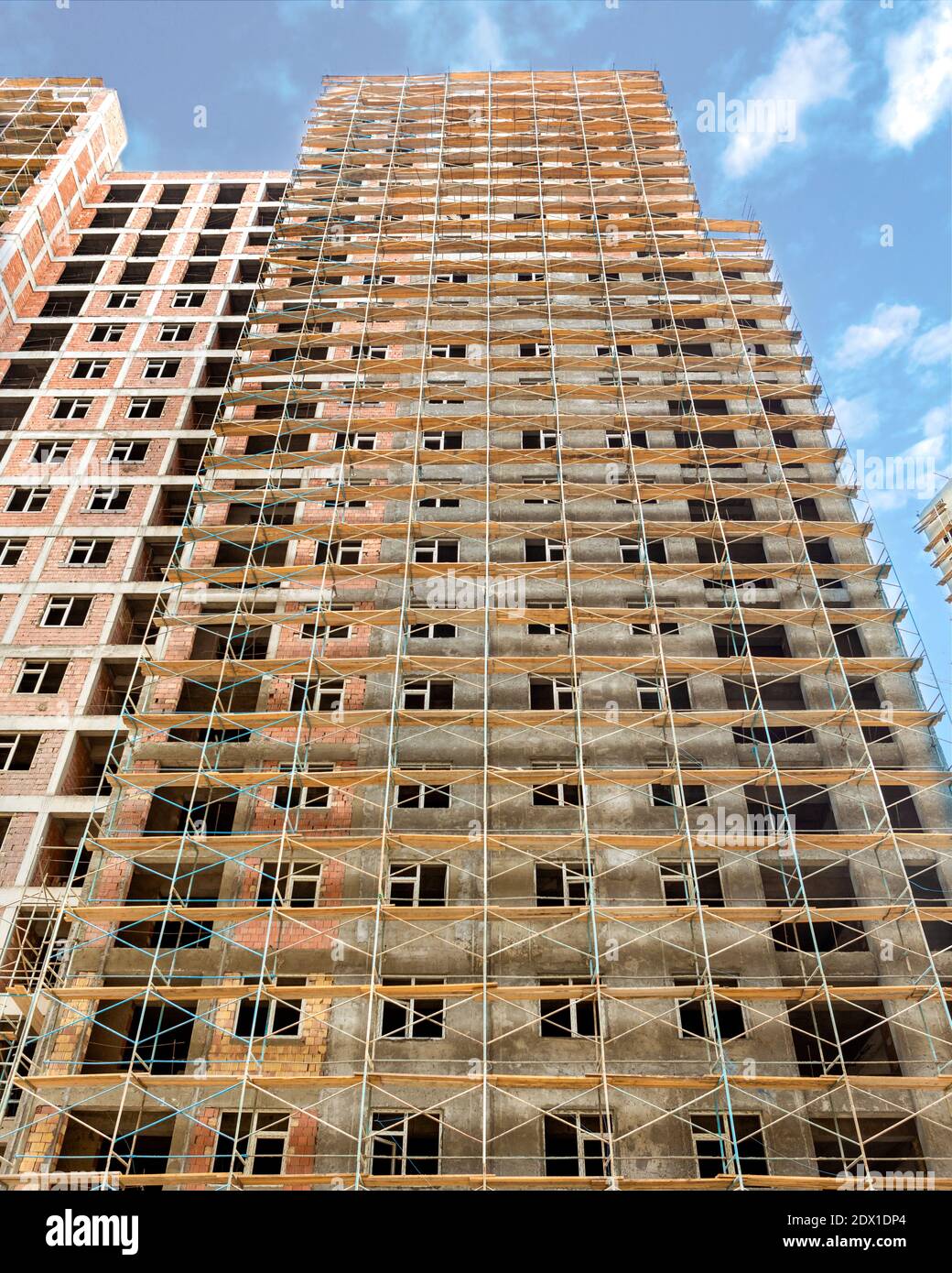 High buildings with scaffold at the construction site Stock Photo - Alamy