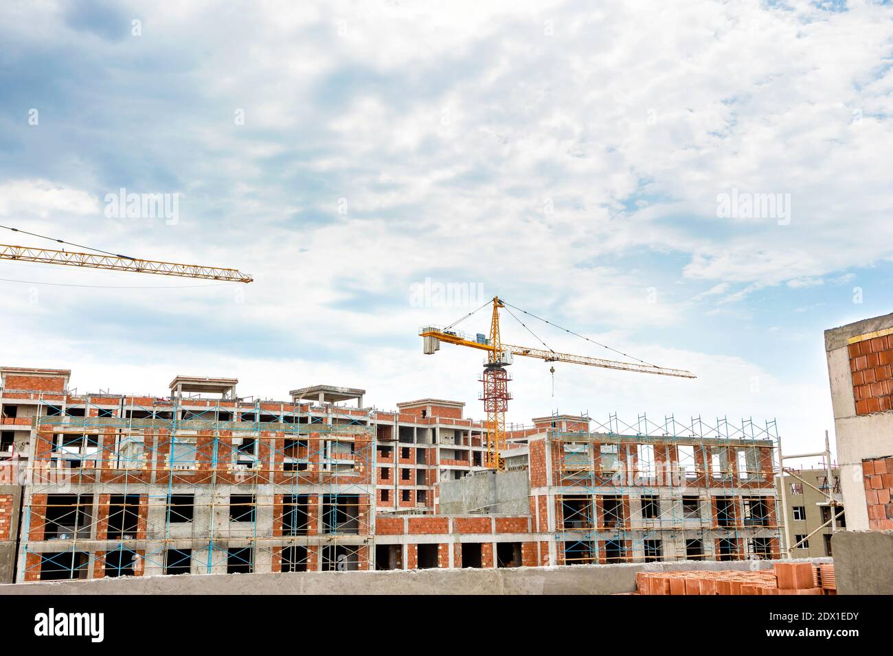 High buildings scaffold with crane at the construction site, top view ...