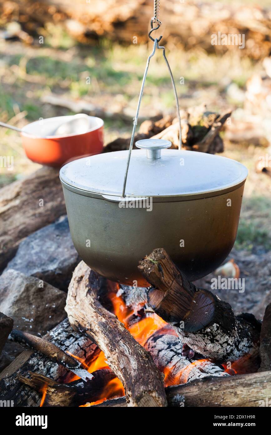 Preparing of a meal on open fire. Bonfire and cauldron Stock Photo - Alamy