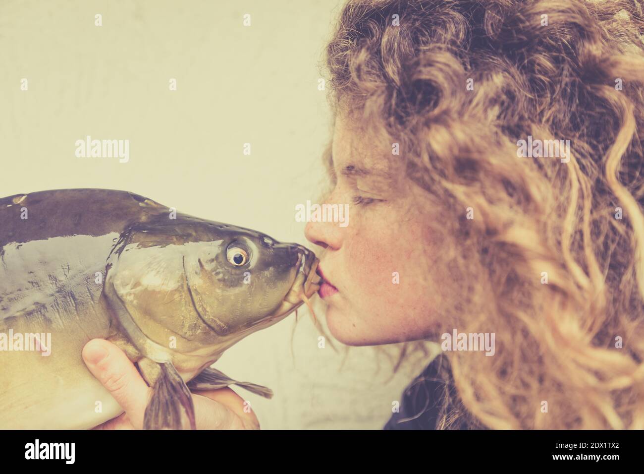 Young woman kissing fish hi-res stock photography and images - Alamy
