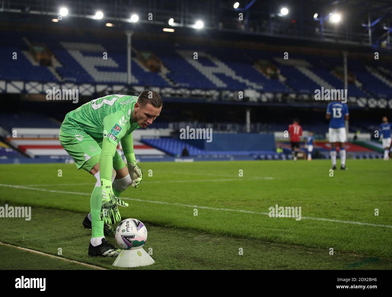 Everton goalkeeper Robin Olsen collects a disinfected match ball from a ...