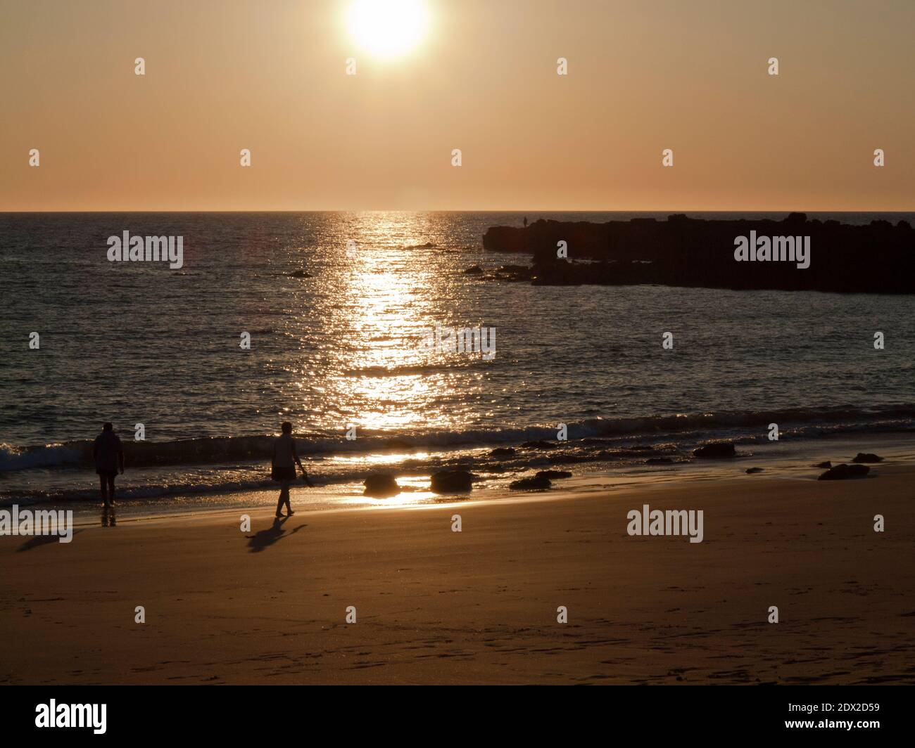 Tourists along the beach by the Indian Ocean at sunset. Middle Lagoon ...