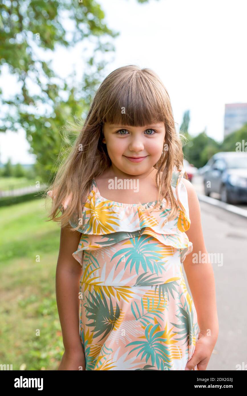 Close-up portrait of a child girl 5-7 years old. Summer in city. Happy ...