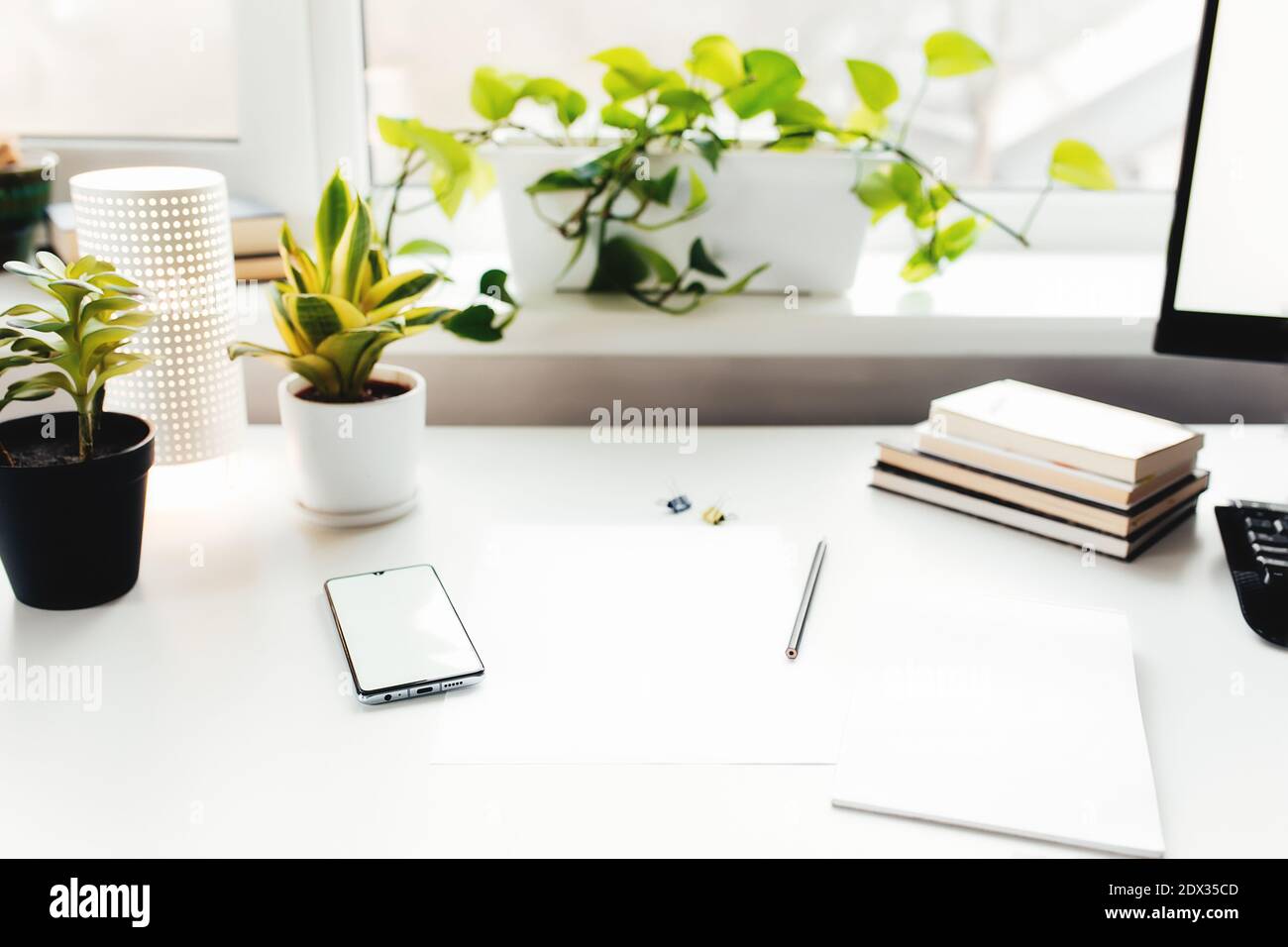 Smartphone on white table, work from home, office stuff Stock Photo - Alamy