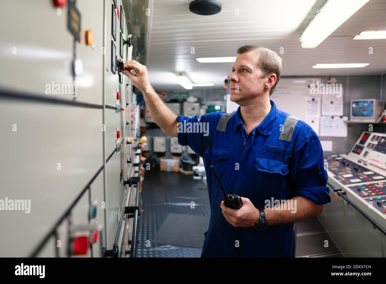 Marine engineer officer controlling vessel engines and propulsion in ...
