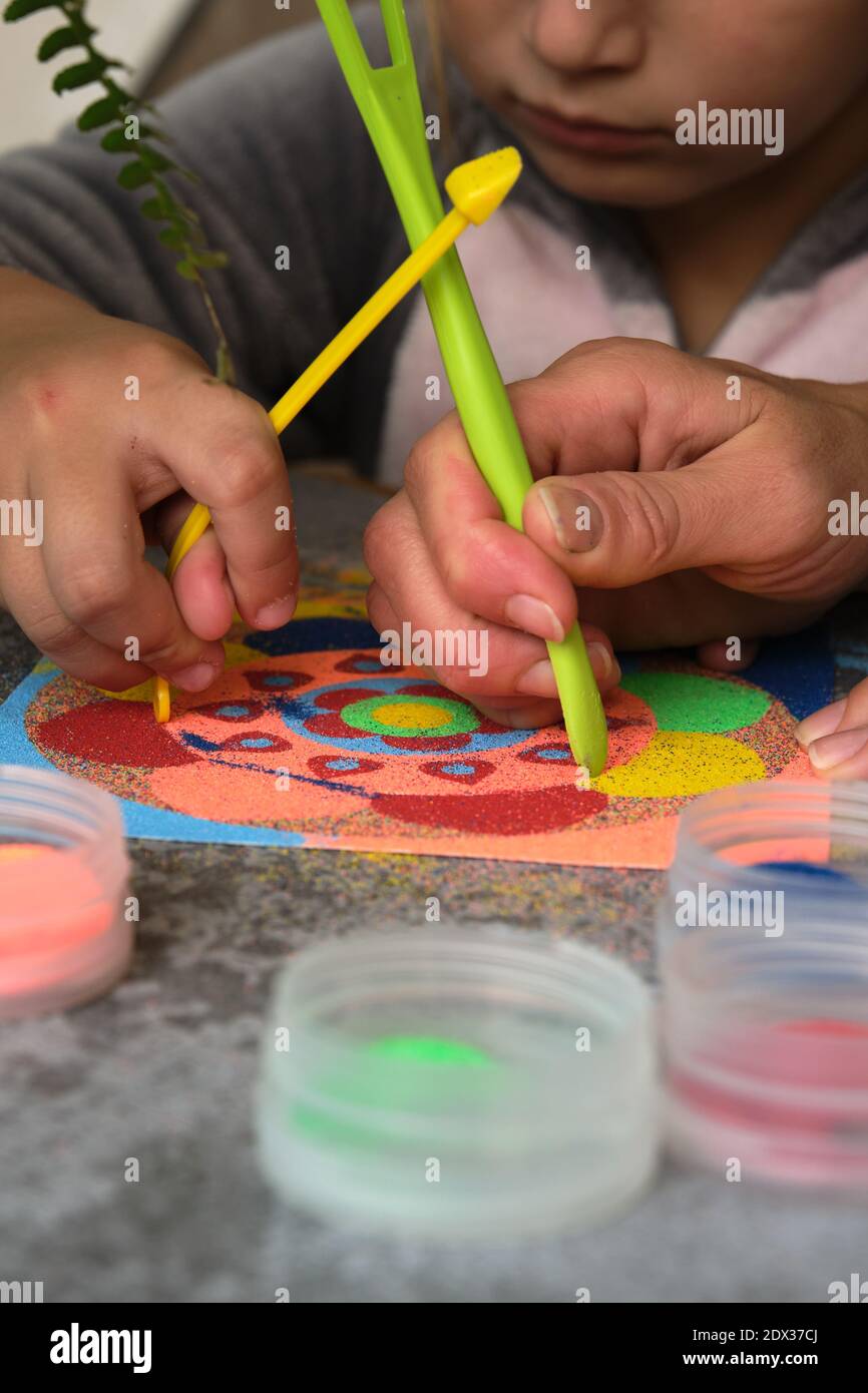 a mandala made of colored sand, the mom with the girls Stock Photo - Alamy