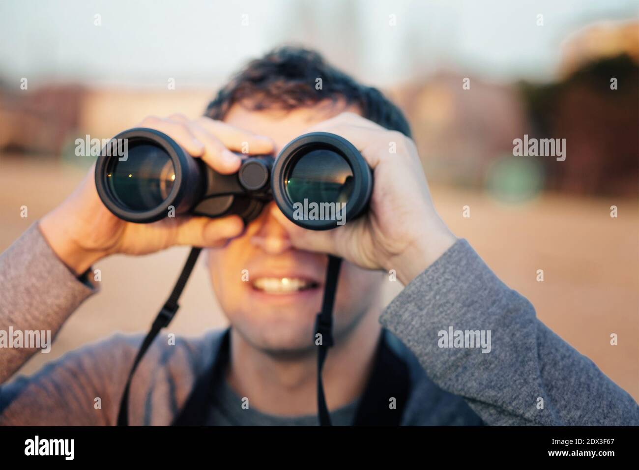 Man looking through binoculars hi-res stock photography and images - Alamy