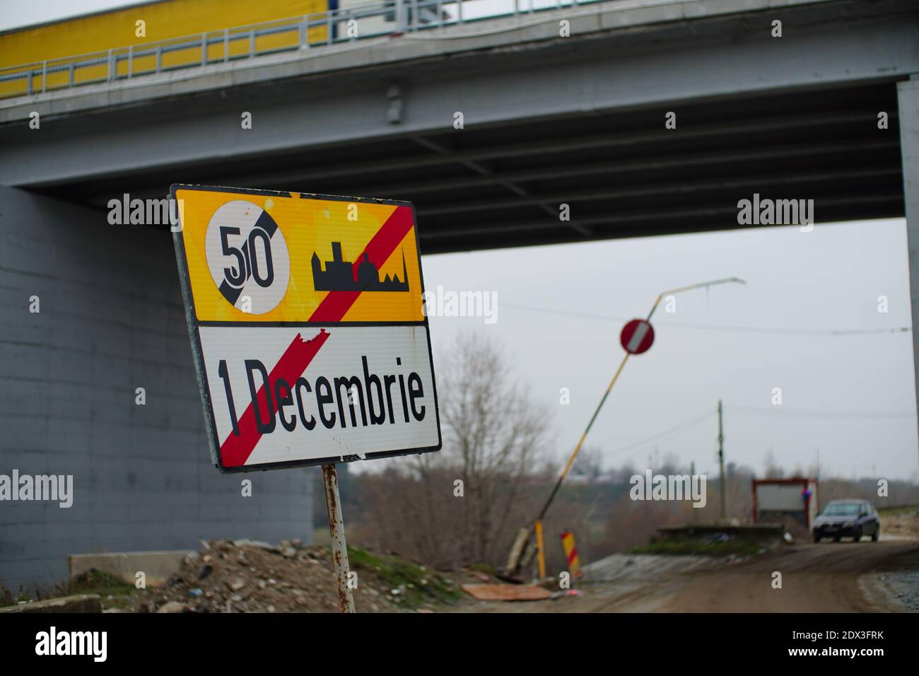 An old road sign indicating speed limit beside a bridge Stock Photo - Alamy