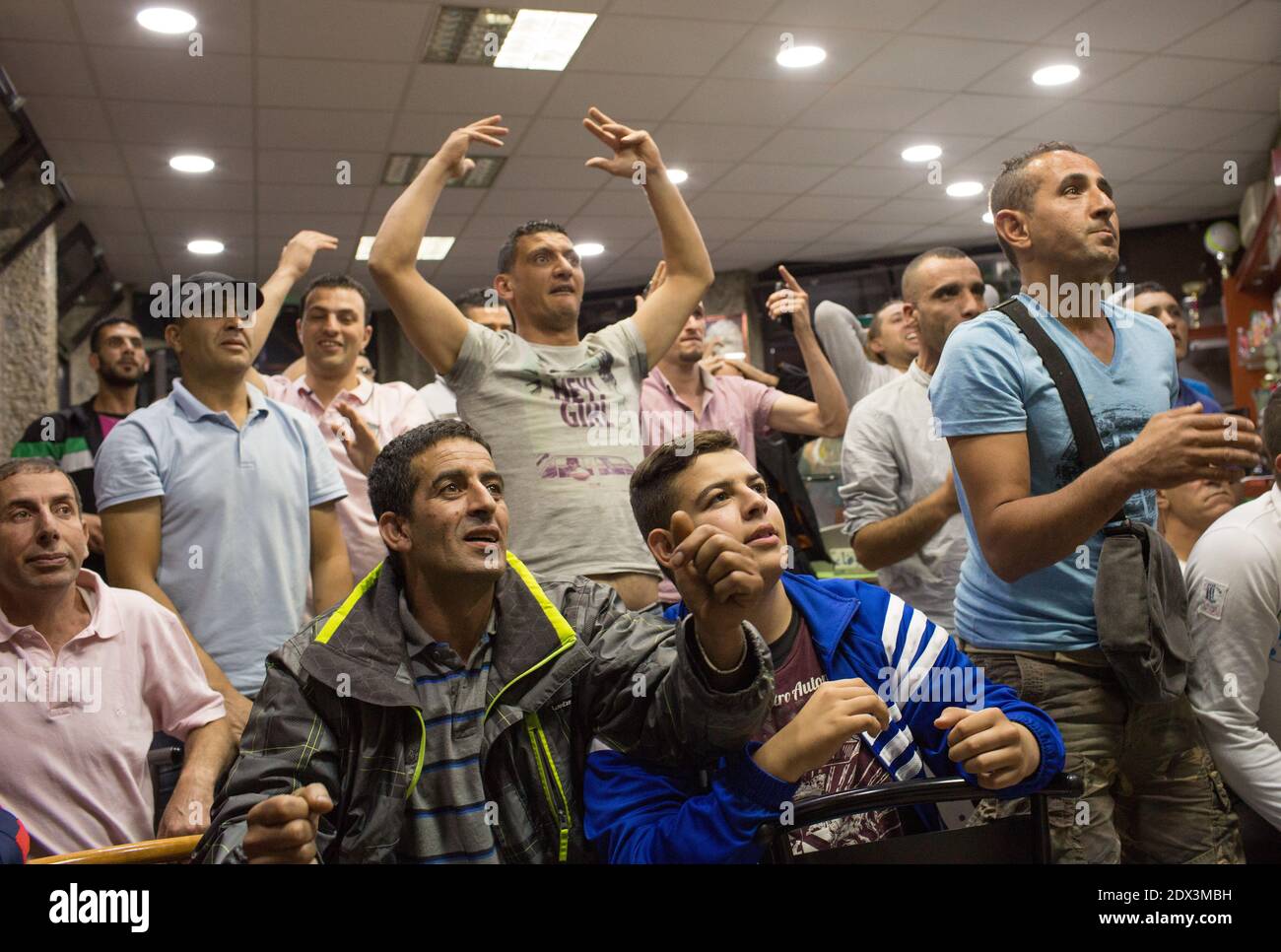 Algeria soccer fans watch in a bar their national team match against ...
