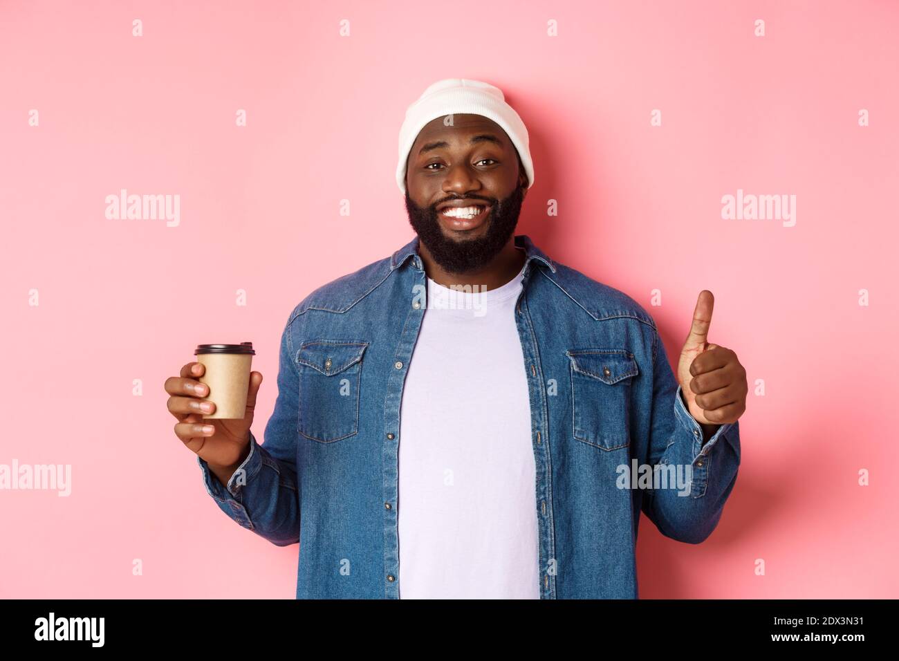 Handsome african-american hipster man showing thumb up, drinking coffee ...