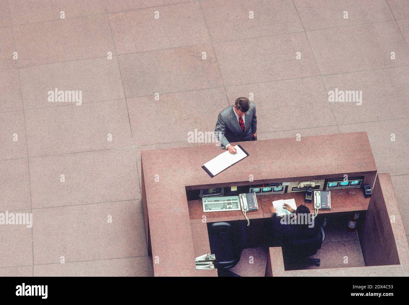 Visitor Signing in A building's Log at a Security Desk, USA Stock Photo ...