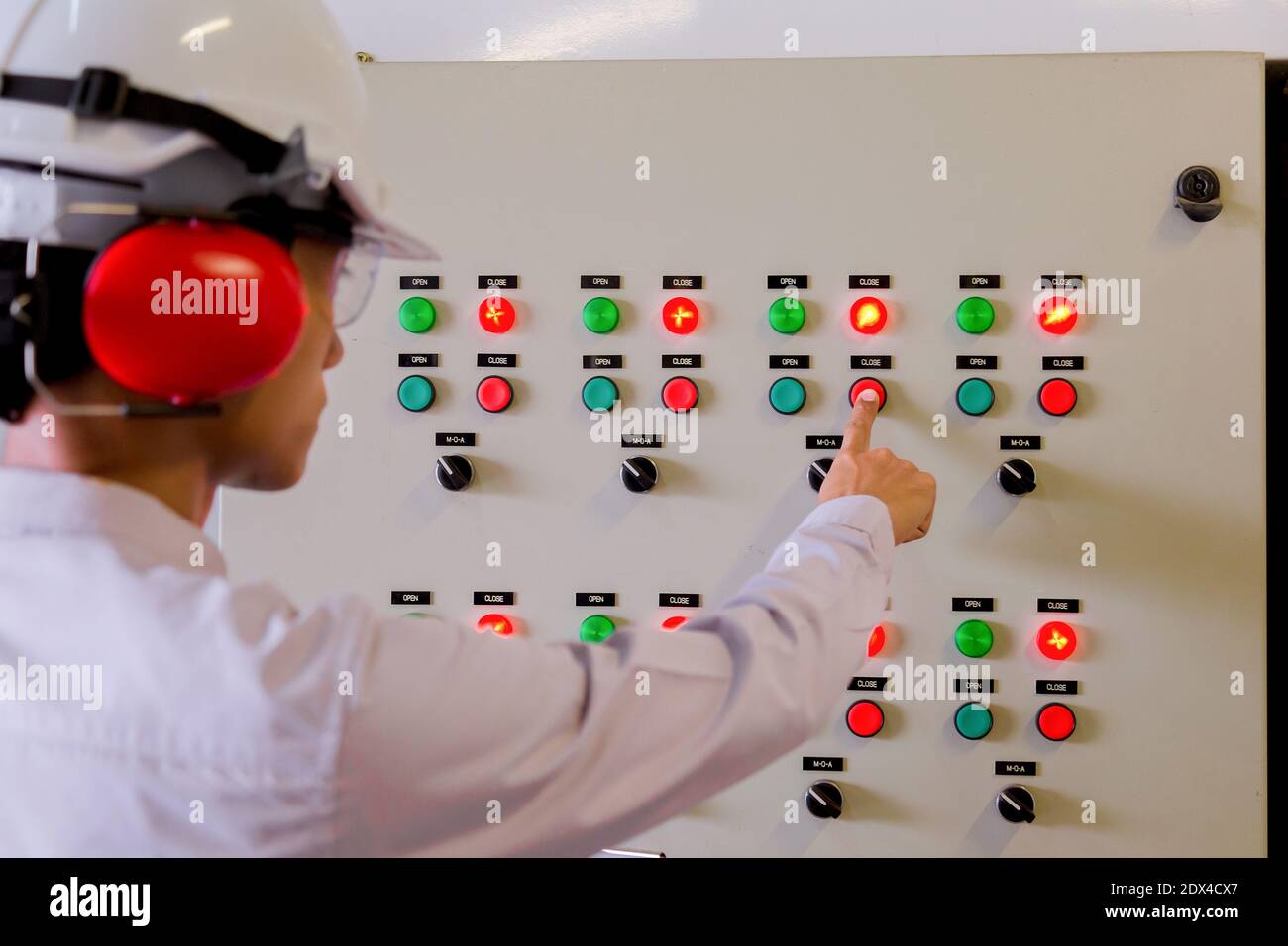 Technician Operating Push Buttons In Factory Stock Photo - Alamy