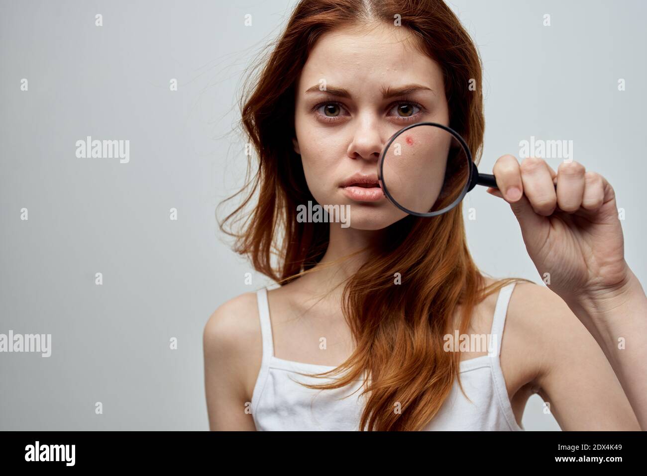 pretty woman with loose hair skin problems magnifier in hands Stock ...