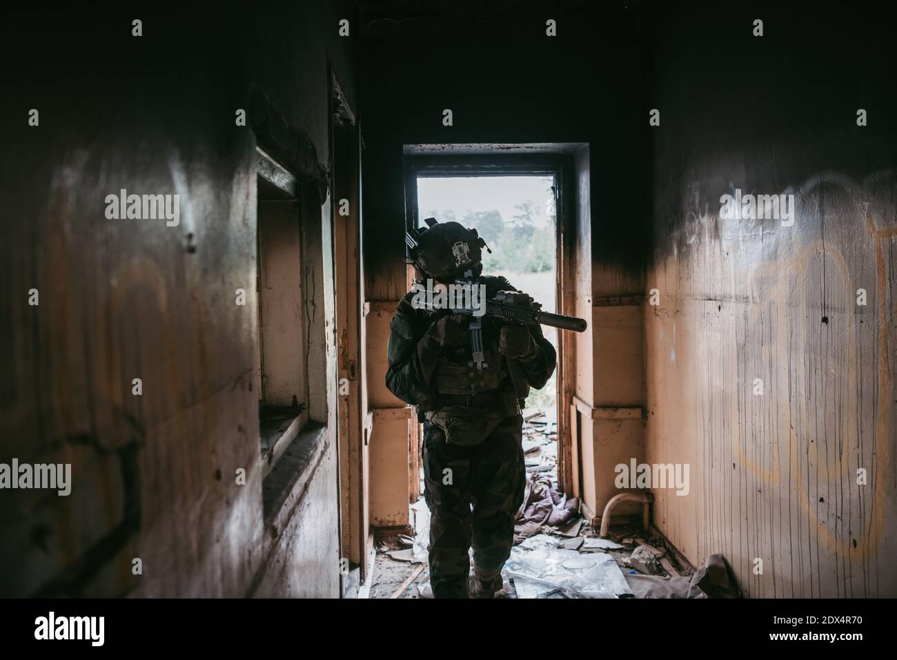 Soldier in combat. Urban combat training, soldier entering abandoned ...