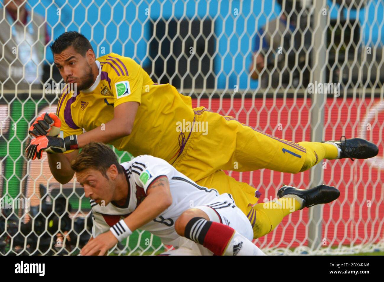 Germany's Mesut Oezil battling Argentina's Sergio Romero in Soccer ...