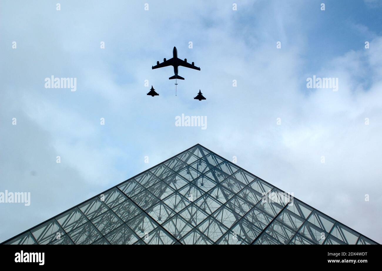 Planes are flying over Le Louvre Pyramide prior to the annual Bastille ...