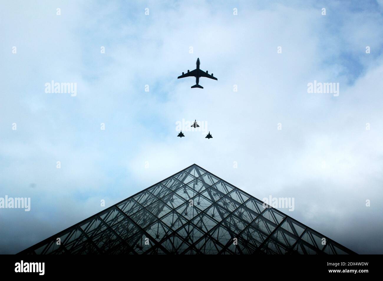 Planes are flying over Le Louvre Pyramide prior to the annual Bastille ...