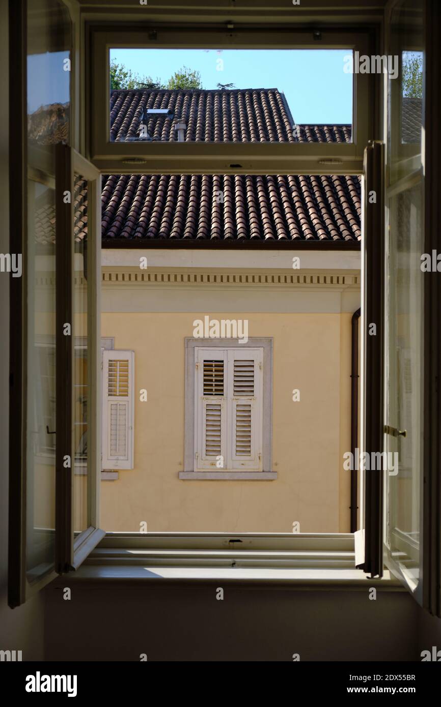 view through window of building across in Italian city Stock Photo - Alamy