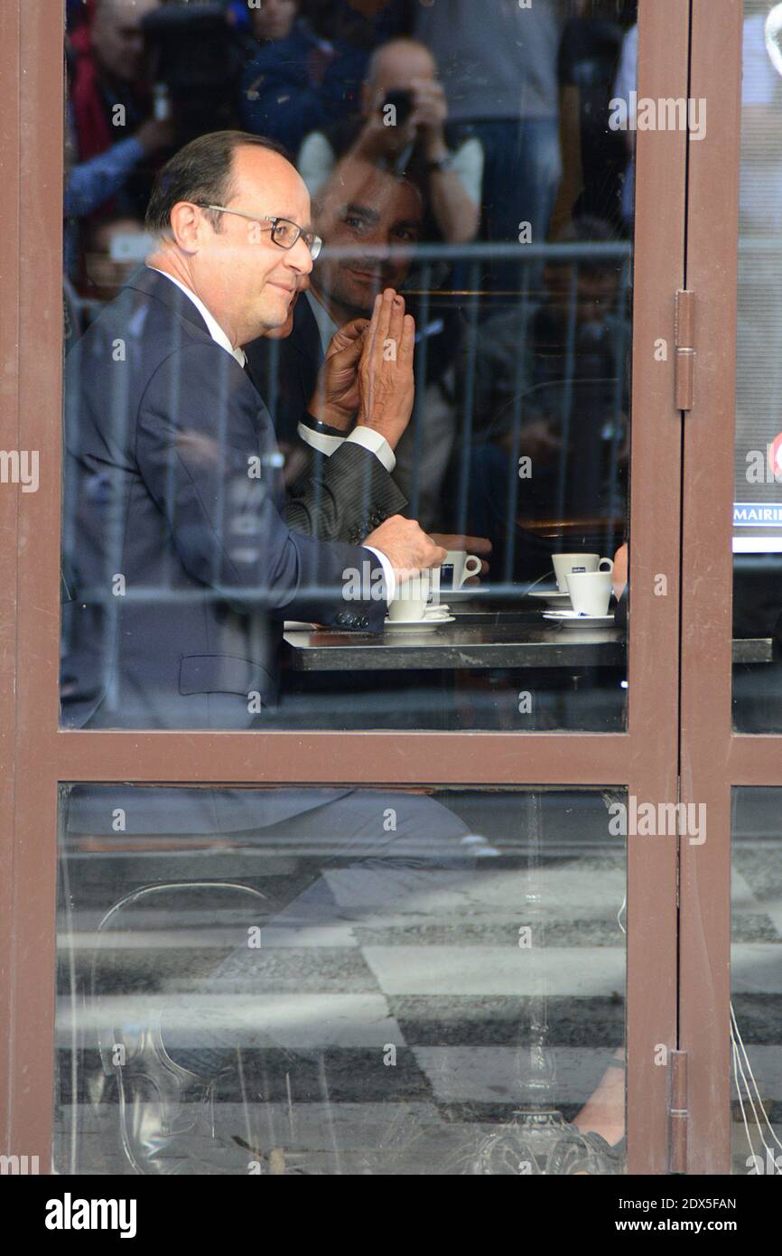 French President Francois Hollande drinks a cup of coffee during the ...