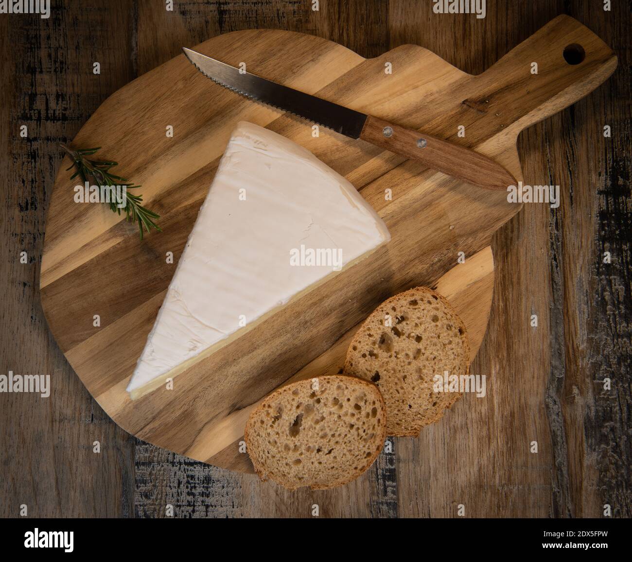 Brie cheese triangle with bread and parsley Stock Photo - Alamy
