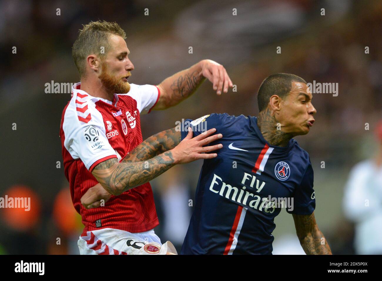 Reims Antoine Devaux battling PSG Gregory Van der Wiel during the ...
