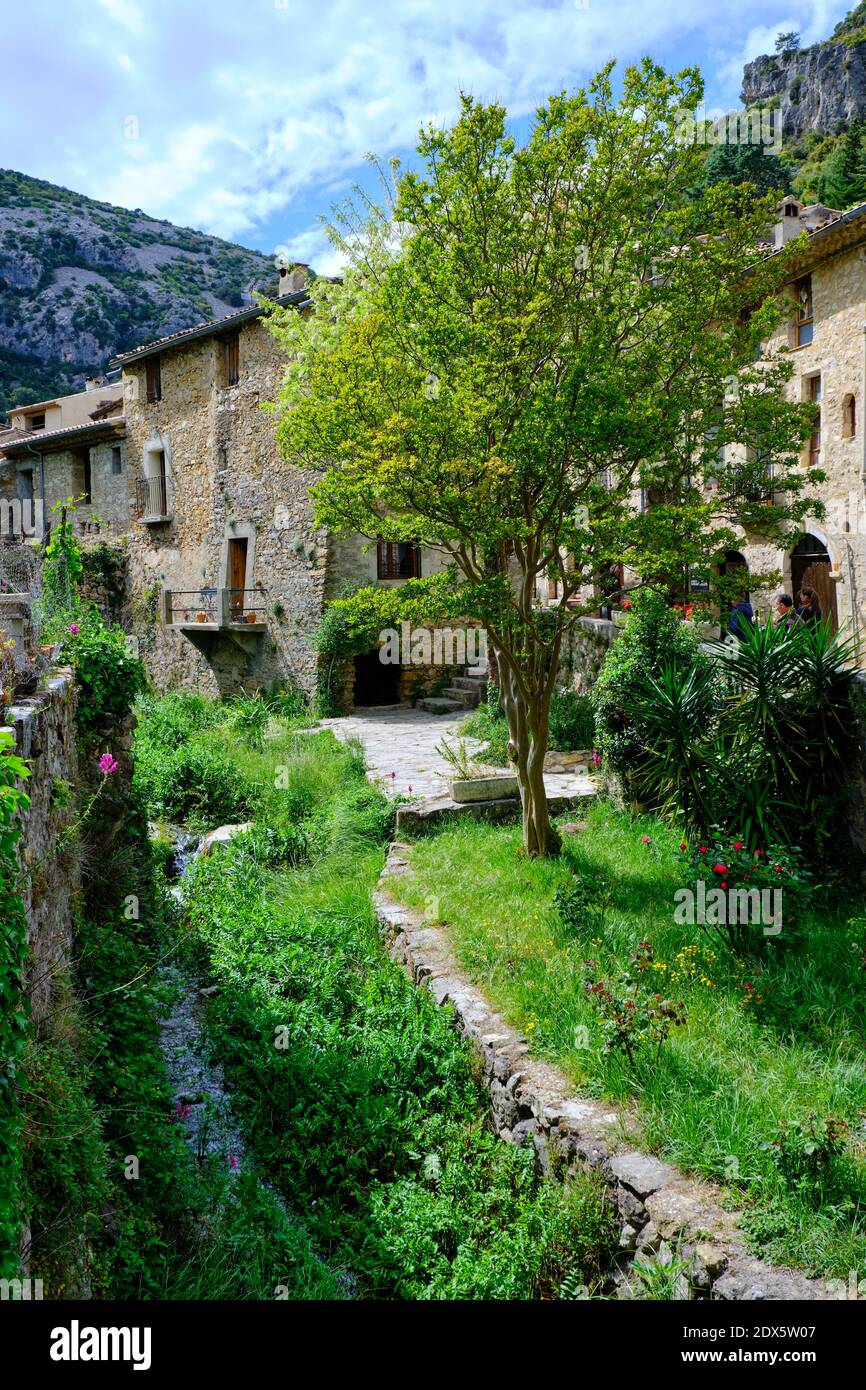 French countryside road of grass leading to old rocky house Stock Photo ...