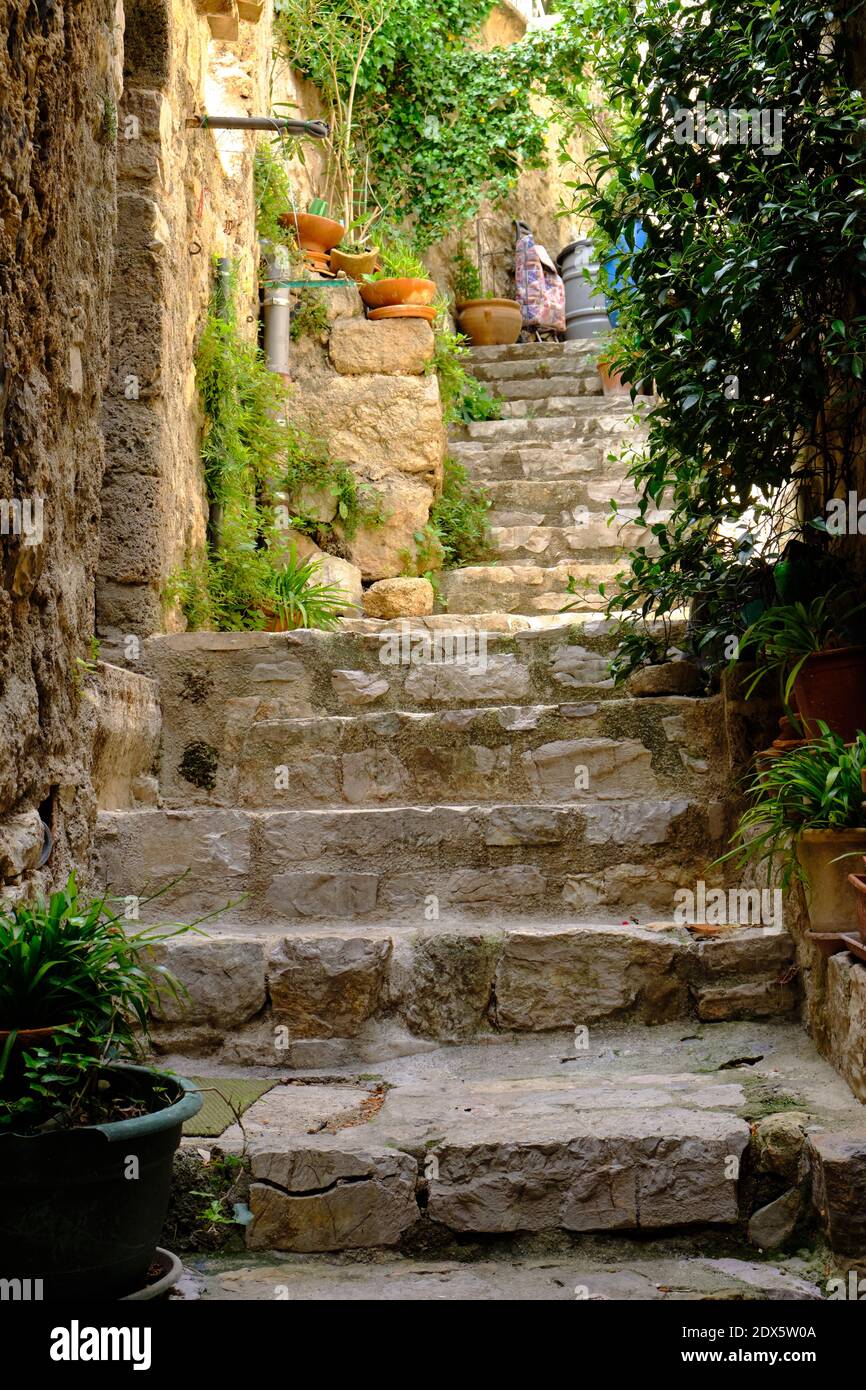 old outdoors street staircase going up, with rock stairs bordered by ...
