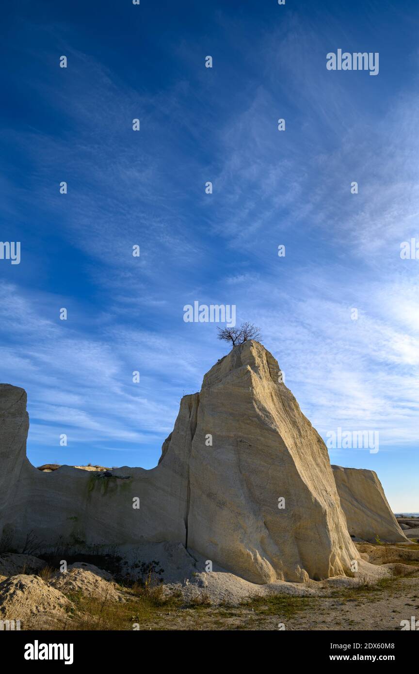 Limestone rock with tree on the top at limestone quarry Stock Photo - Alamy