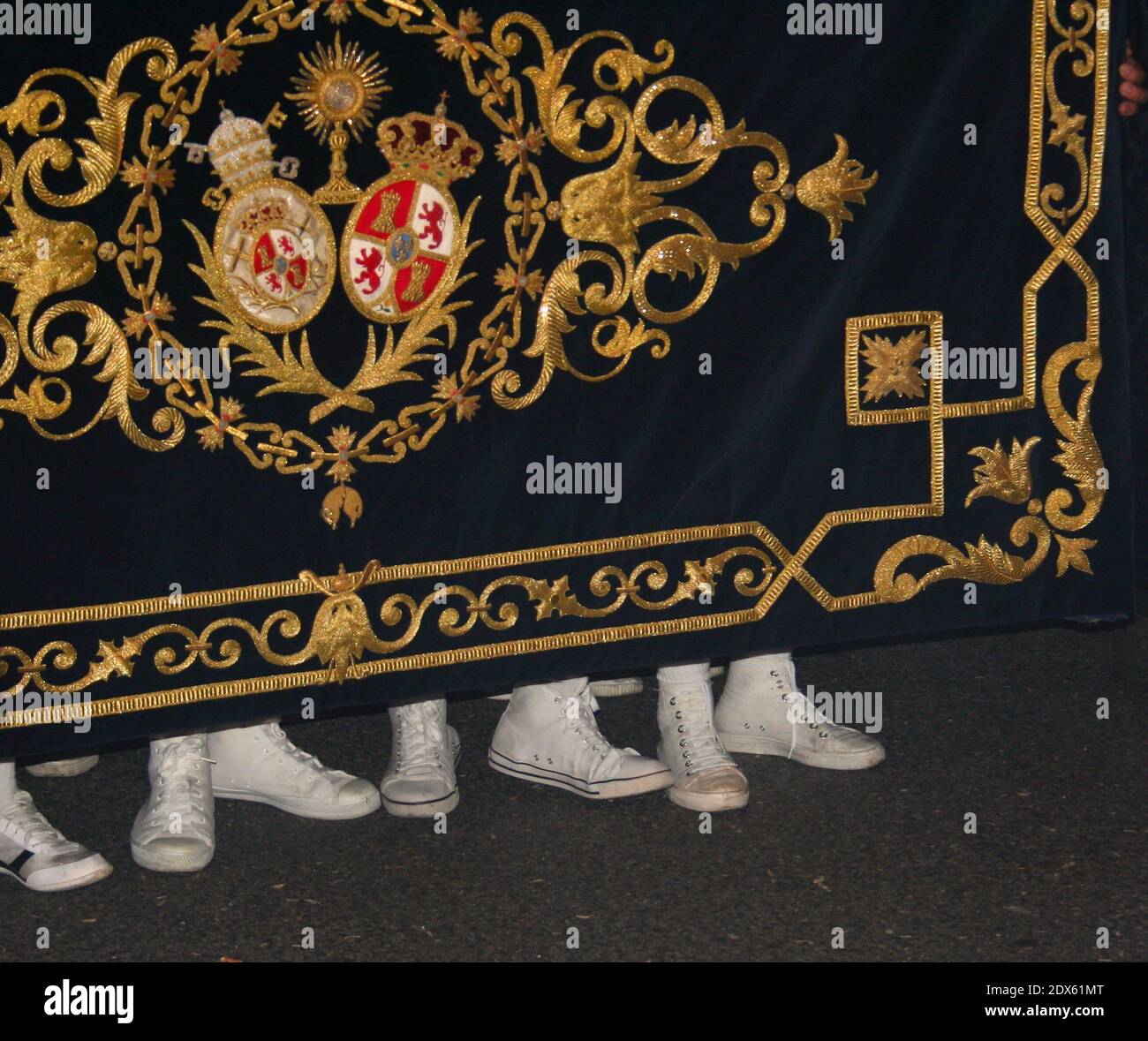 Row of baseball boot clad feet of the costaleros under an Easter ...