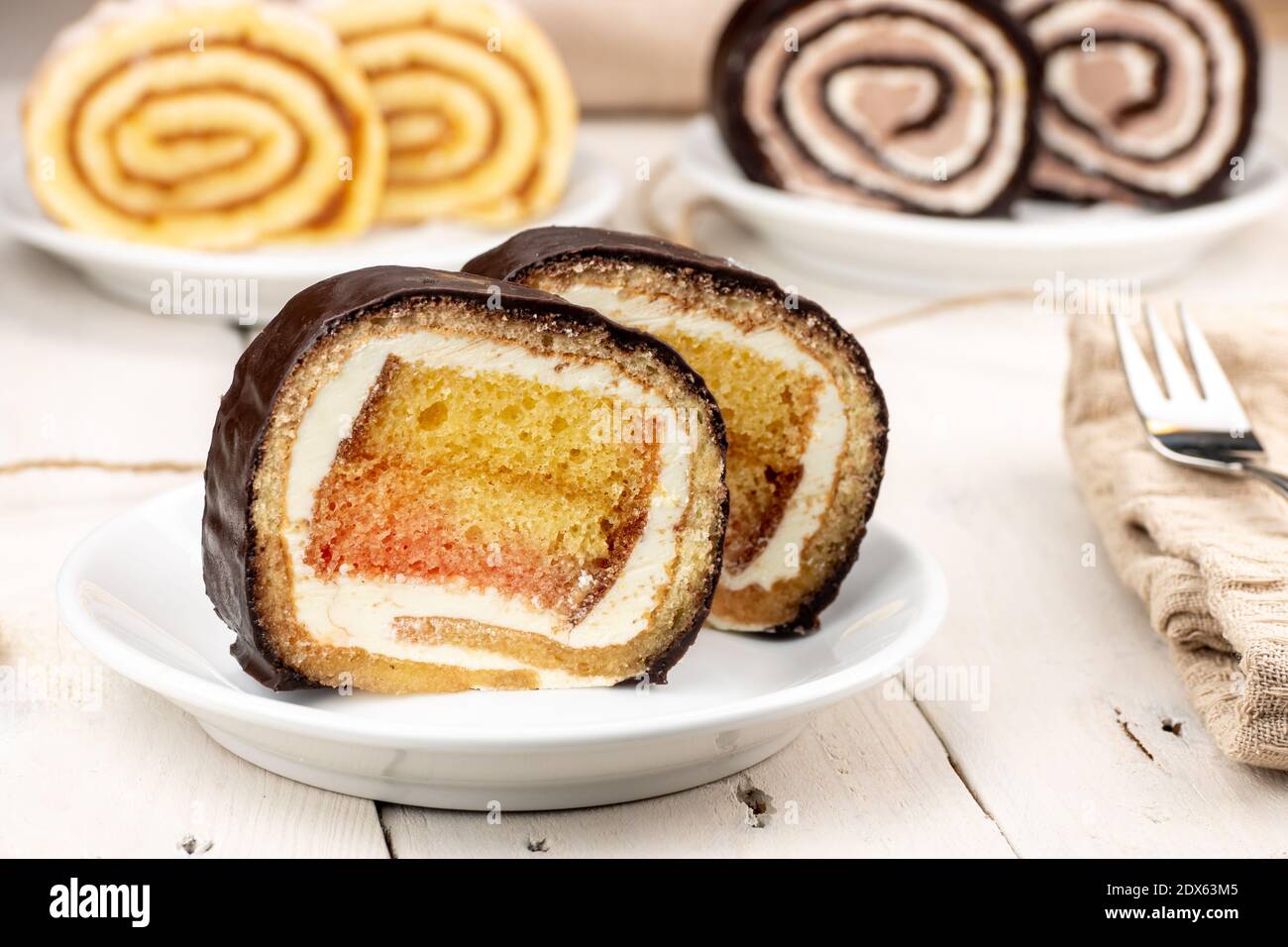 Punch swiss roll dessert with chocolate topping. In the background ...