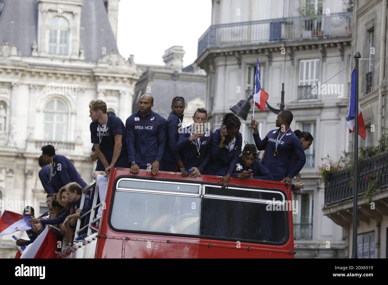 French Athletic team celebrates in a bus running through the streets in ...