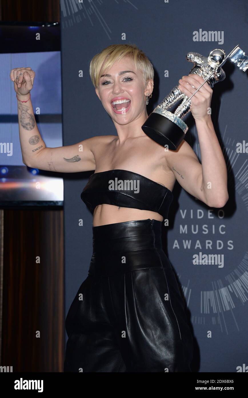 Miley Cyrus poses in the press room during the 2014 MTV Video Music ...